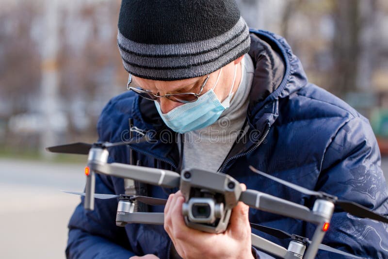 Surveyor in a Protective Mask Prepares a Quadcopter for Flying Around ...