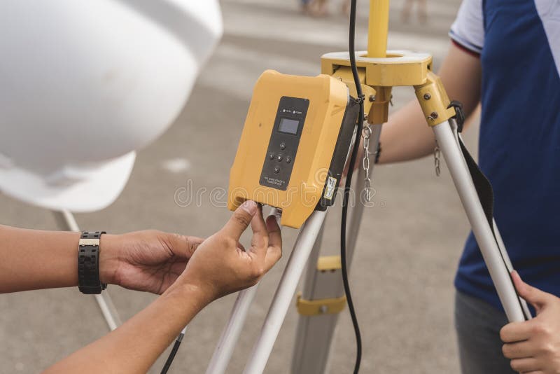 A Surveyor Setting Up a Wireless Data Transceiver. Surveying Equipment ...