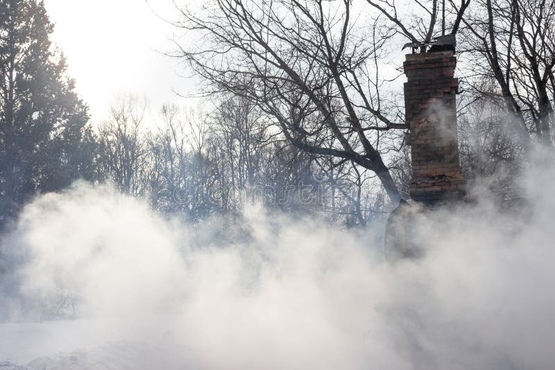 The Surviving Chimney Surrounded by Dense Smoke after a House Fire ...