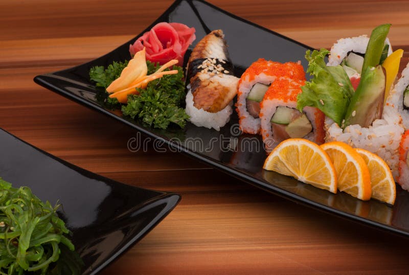 Sushi on a black plate stock image. Image of rice, japanese - 76516257