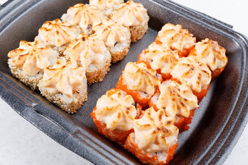 Sushi in Plastic Packaging. Baked Sushi with Flying Fish Roe. Sushi in ...