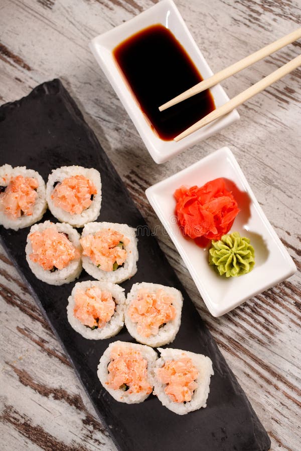 Sushi Roll Covered with Chopped Salmon and Caviar is Served on ...