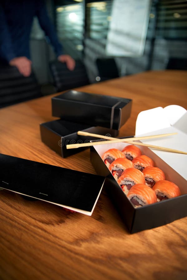 Sushi Roll Delivery Box on Workspace with Chopsticks. Office Lunch ...