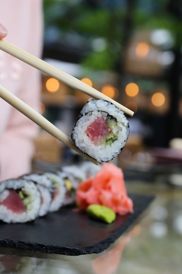 Sushi Roll Taken by a Chopstick, Vertical Stock Image - Image of ...
