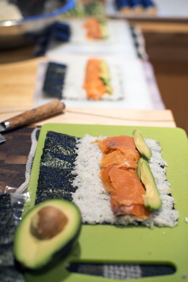 Sushi rolls in process stock image. Image of cutting - 131012463