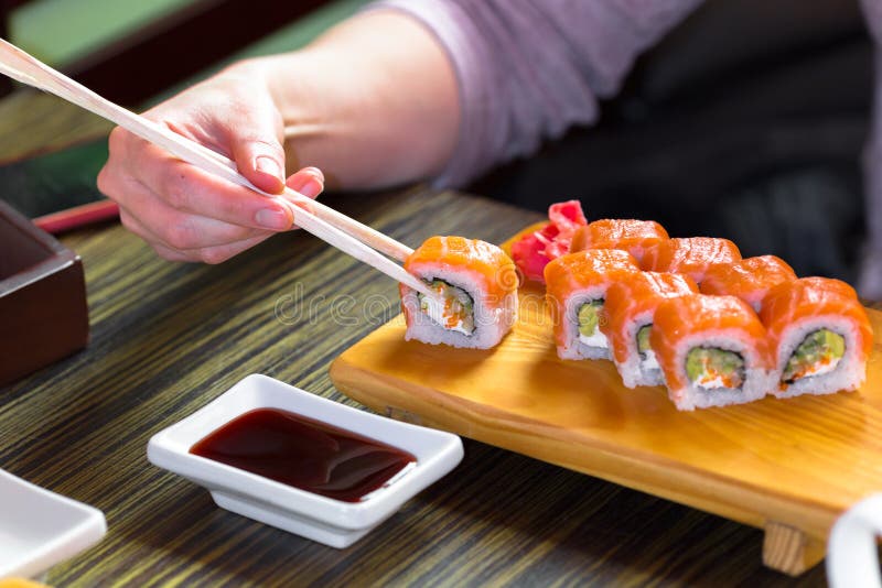 Sushi rolls on the table stock photo. Image of chopsticks - 87877504