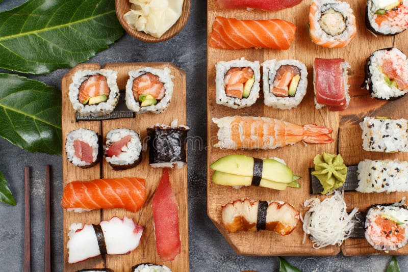 Sushi Set Nigiri and Sushi Rolls on Rectangular Wooden Plates Stock ...