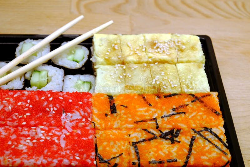 Sushi on Square Tray on Brown Wooden Table Side View Closeup Stock ...