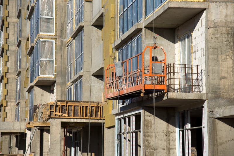 Suspended Construction Cradle on the Background Facade of the Building ...