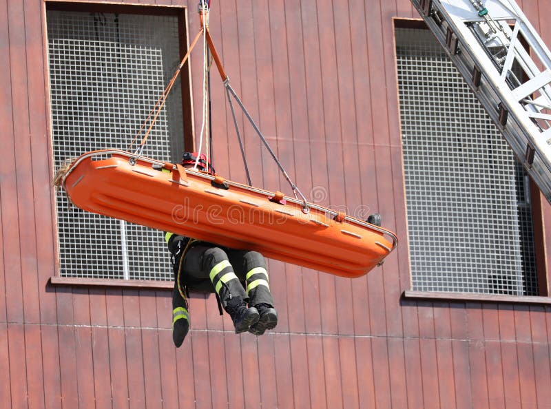 Suspended Firefighter with Stretcher with People during Practice Stock ...