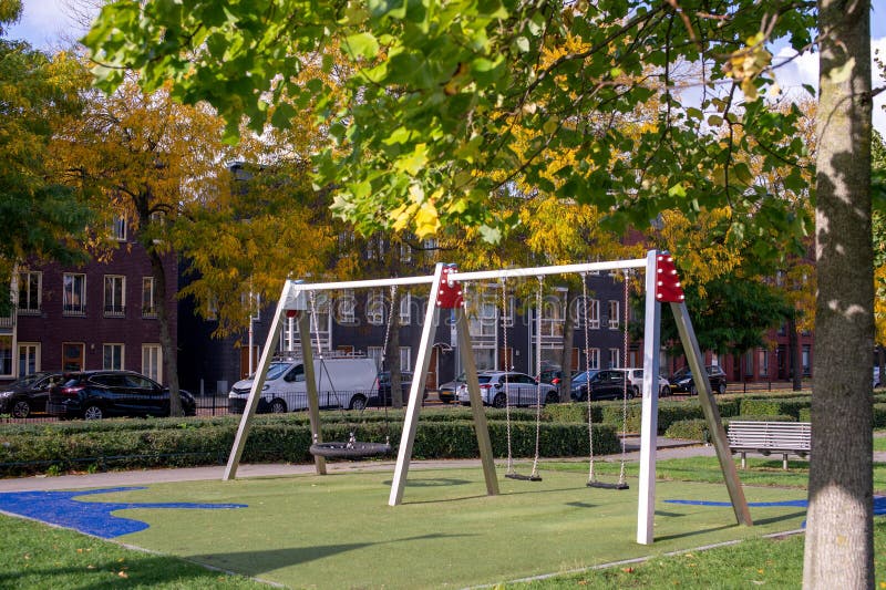 Suspended Modern Swing on the Playground. Soft Lawn Covering Stock ...