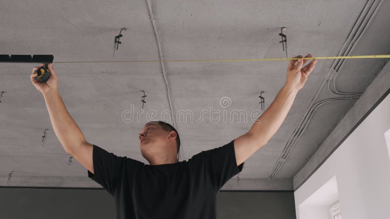 Professional Worker Measuring Ceiling with a Tape Stock Video - Video ...