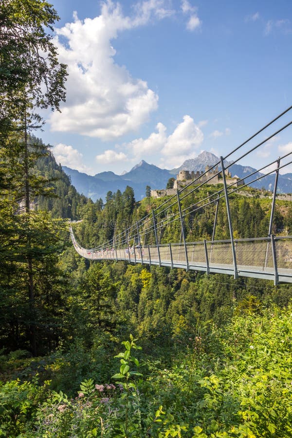 Suspension bridge in Alps stock image. Image of outdoor - 198167491