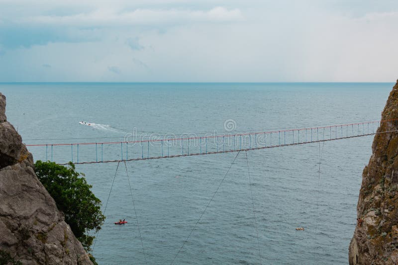 Suspension Bridge Hanging Above the Sea between Two Cliffs Stock Image ...