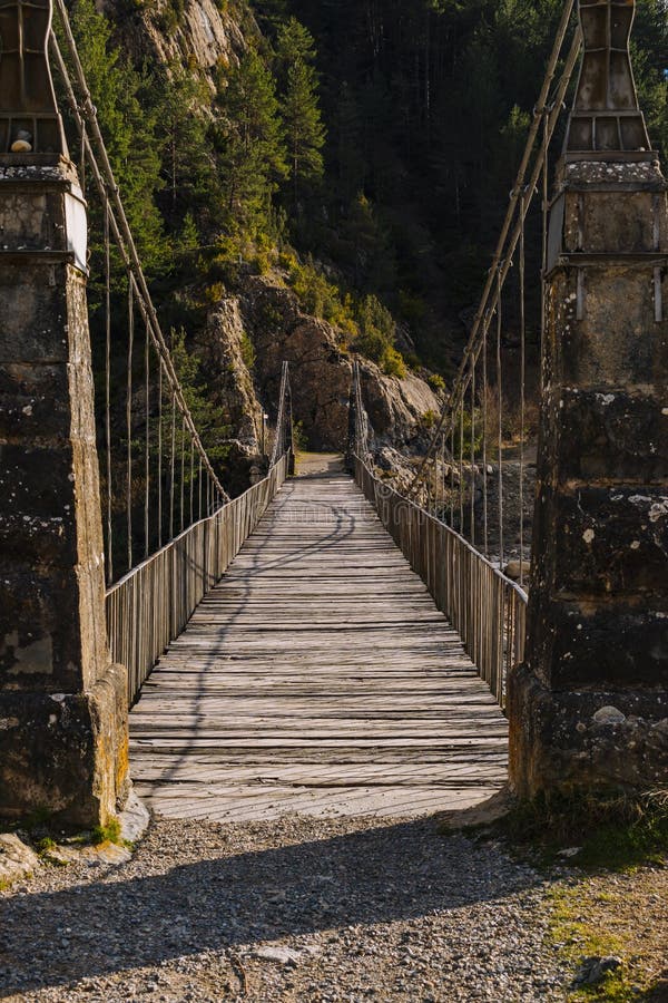 Suspension Bridge Over a River with a Wooden Walkway Stock Photo ...