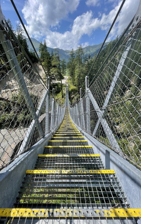 Suspension Bridge between the Trees in the Alps Mountains in Kals am ...