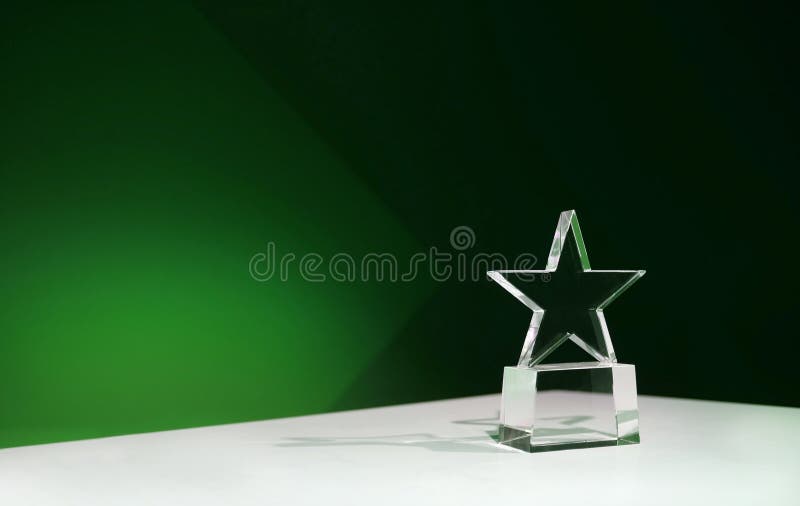 Star-shaped Crystal Prize on a Table with Green Spotlights and Copy ...