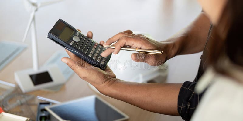 Sustainability and Engineering. Engineer Using Calculator for ...