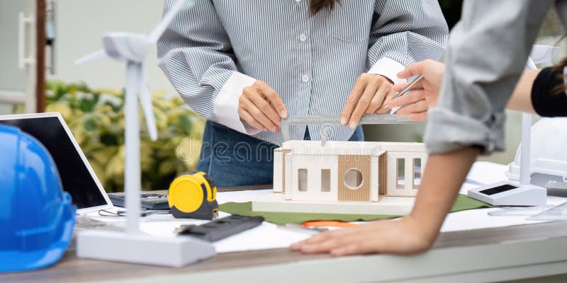 Sustainability in Engineering: Team Collaborating on Eco-friendly House ...