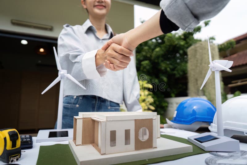 Sustainability Engineers Shaking Hands Over Architectural Design Stock ...