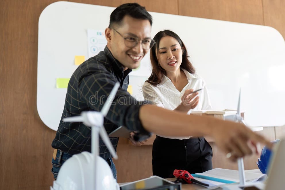 Sustainability and Innovation. Engineers Discussing Renewable Energy Solutions in a ...