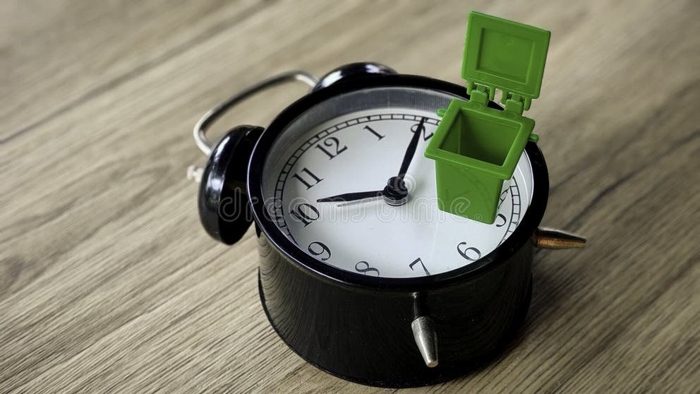 Sustainability in Time: Green Miniature Garbage Bin on a Clock Stock ...
