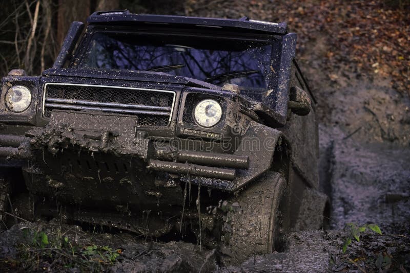 SUV Covered with Mud Stuck in Deep Puddle. Stock Image - Image of ...