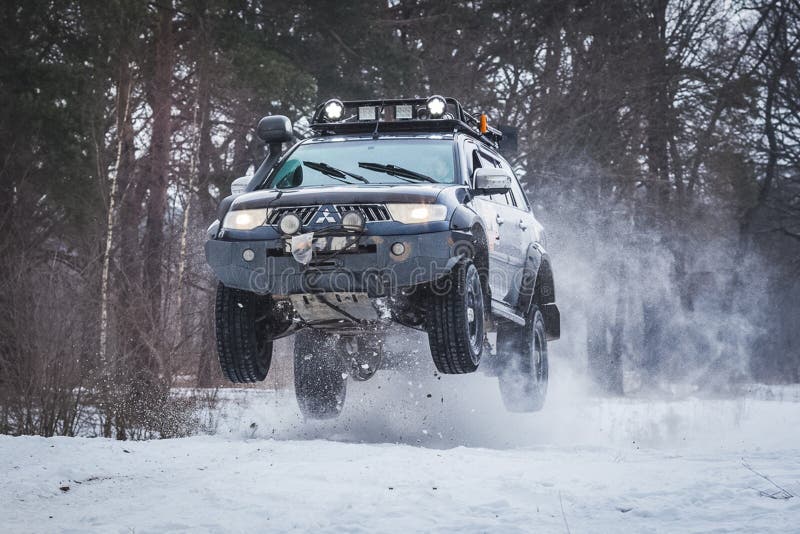 SUV Jumped on Rise of Snow Winter Forest Editorial Image - Image of ...