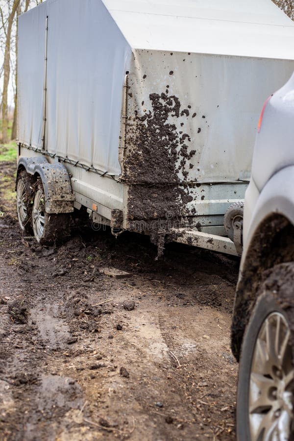 SUV Pulls a Dirty Car Trailer Off-road. Transportation of Goods Stock ...