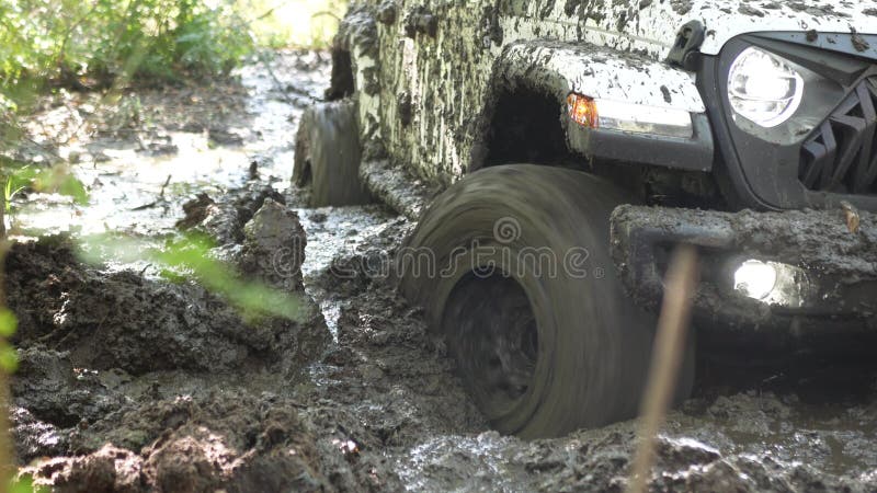 The SUV is Stuck in Deep Mud. All the Wheels are Spinning Stock Footage ...