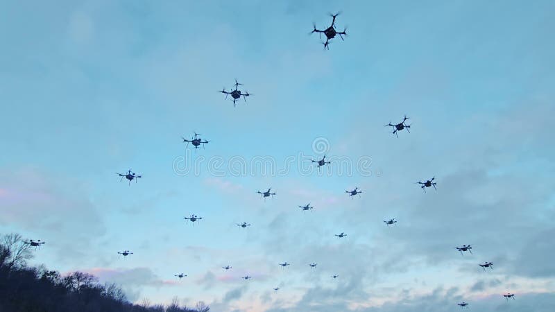 Swarm of Drones Flying at Dusk. a Group of Drones Hovering in the Sky ... Swarm of Drones Flying at Dusk. a Group of Drones Hovering in the Sky ...