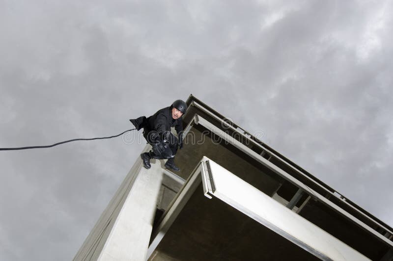 SWAT Team Officer Rappelling and Aiming Gun Stock Image - Image of ...