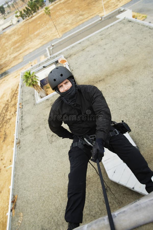 SWAT Team Officer Rappelling from Building Stock Image - Image of black ...