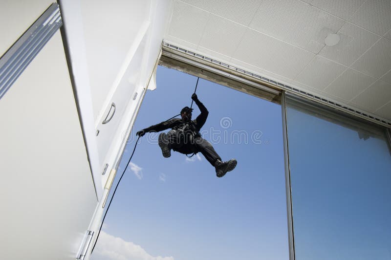 SWAT Team Officer Rappelling from Building Stock Image - Image of ...