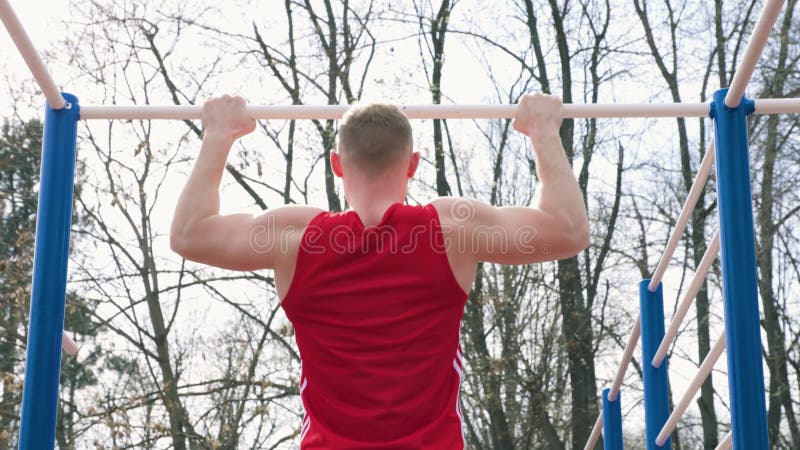Sweat and Endurance Active Guy Doing Pull-Ups at Outdoor Gym Stock ...