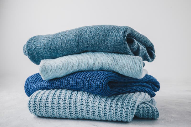 Sweaters. Blue Sweaters Stacked on Gray Background Stock Photo - Image ...