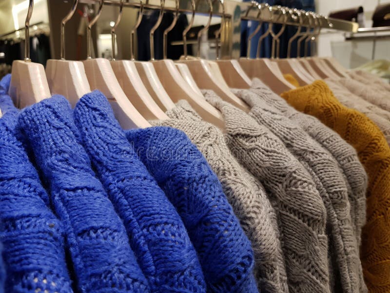 Sweaters Hang on Hangers in a Clothing Store Stock Photo - Image of ...