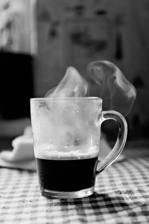 Sweating with Steam Cup of Coffee on a Black and White Table Stock ...