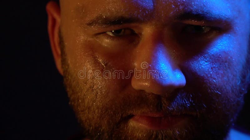 A Sweaty Bearded Man with a Beard and a Scar on His Cheek Looks at the ...
