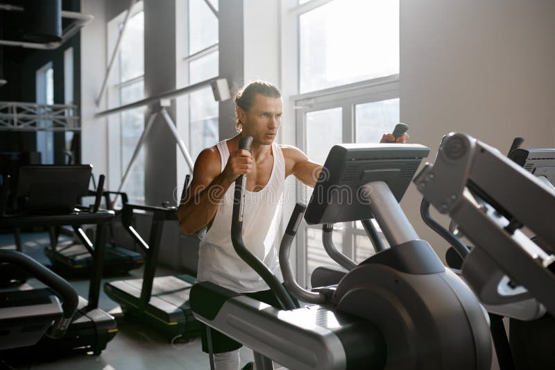 Sweaty Sportsman Doing Cardio Exercise on Orbitrack Training Apparatus ...
