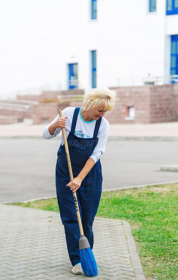Sweeper Worker Cleaning City Street with Broom Tool. Stock Photo ...