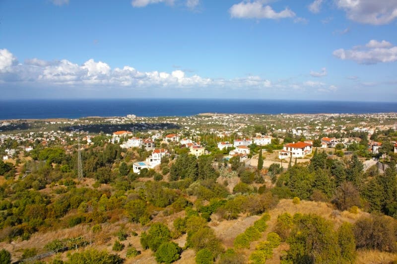 A Panoramic View Showcasing a Valley, the Sea, and Scattered Buildings ...