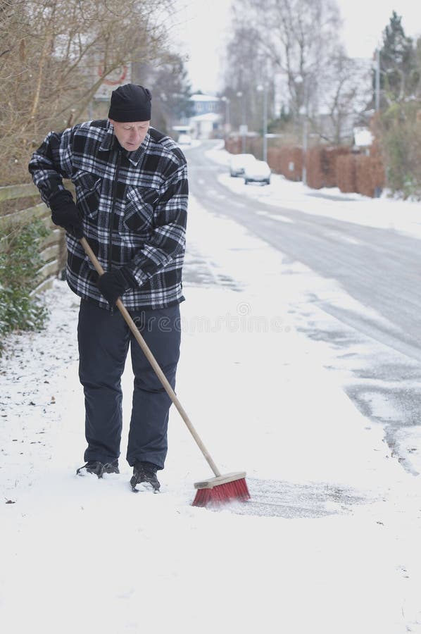 Sweeping snowy sidewalk stock photo. Image of work, snow - 23171998