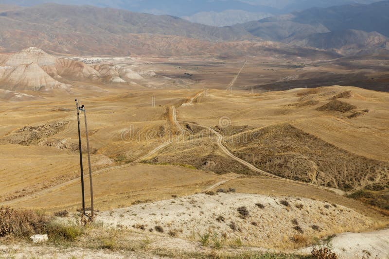 Vast Desert Landscape in Iran Showcasing Rolling Hills and Power Lines ...
