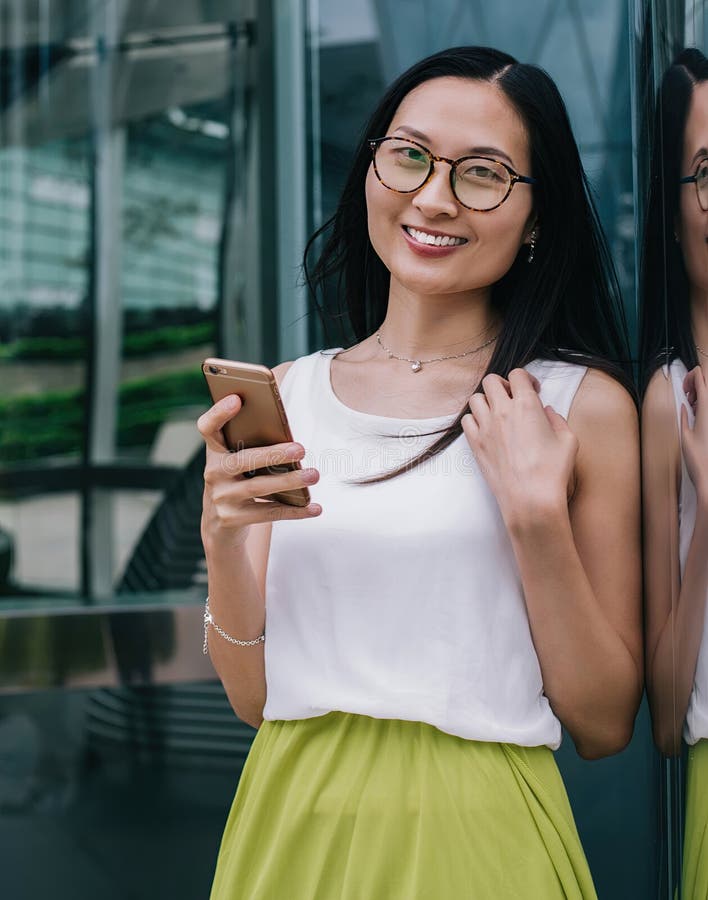Sweet Asian Woman Looking at Camera during Browsing Stock Image - Image ...