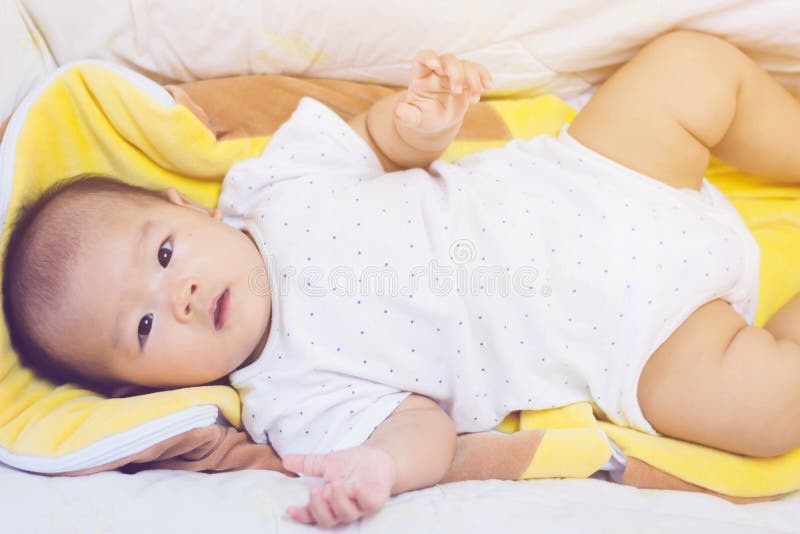 Sweet baby laying on bed stock image. Image of toddler - 88095093