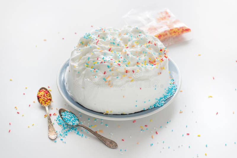Sweet Cake with Blue, Yellow, Red and White Sprinkles Stock Photo ...