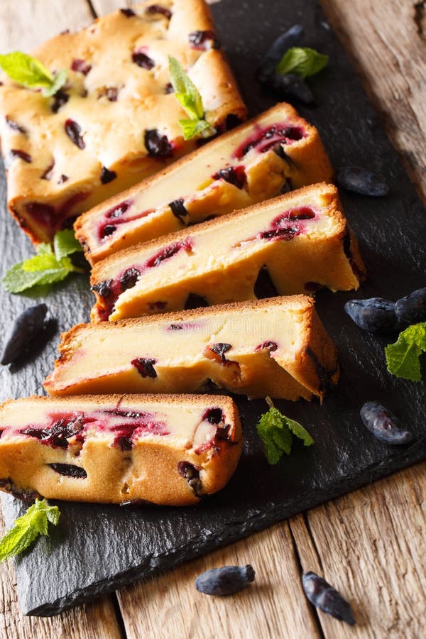 Sweet Cake with Honeysuckle Sliced on the Board Closeup. Vertical Stock ...