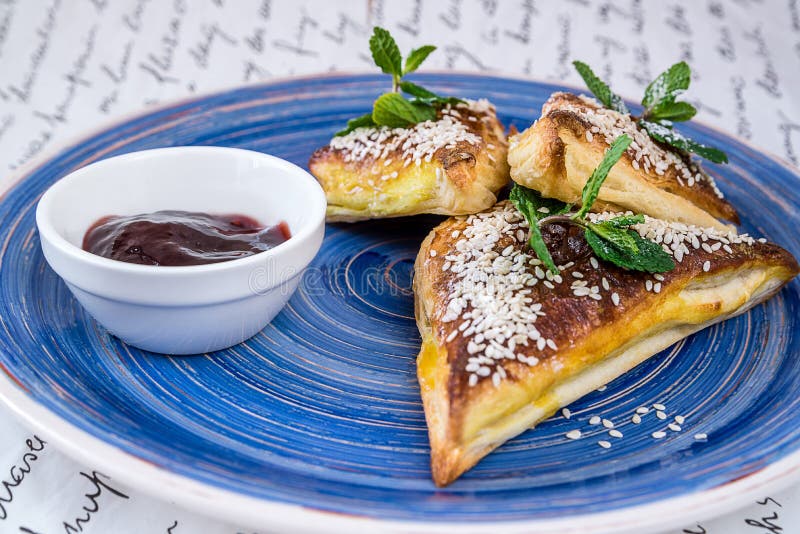 Sweet Cakes Triangular Shape with Sesame Seeds and Jam Stock Photo ...
