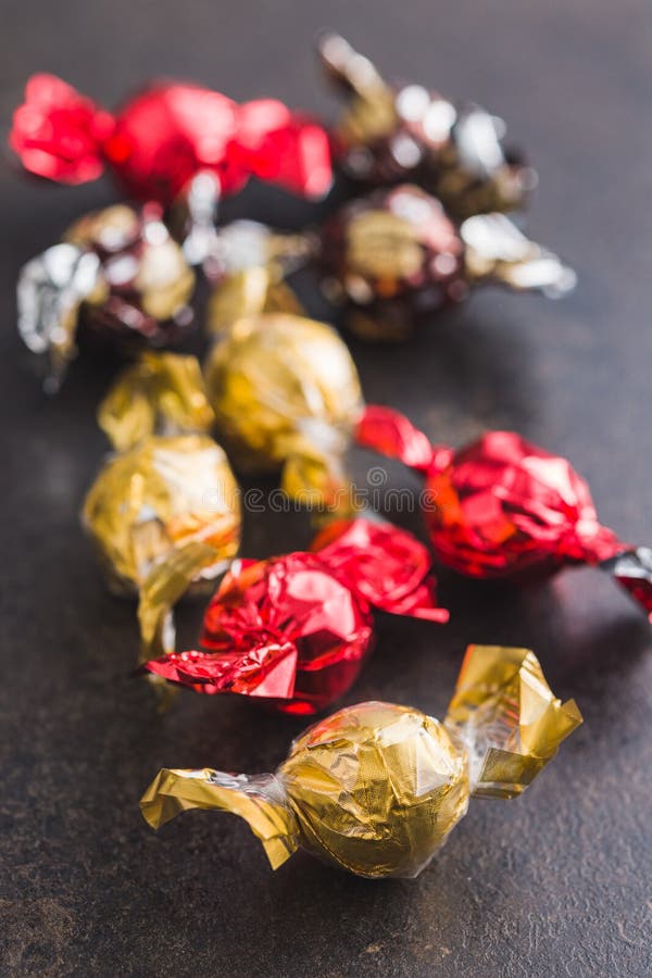 Sweet Candy Wrapped in Foil on Kitchen Table Stock Photo - Image of ...